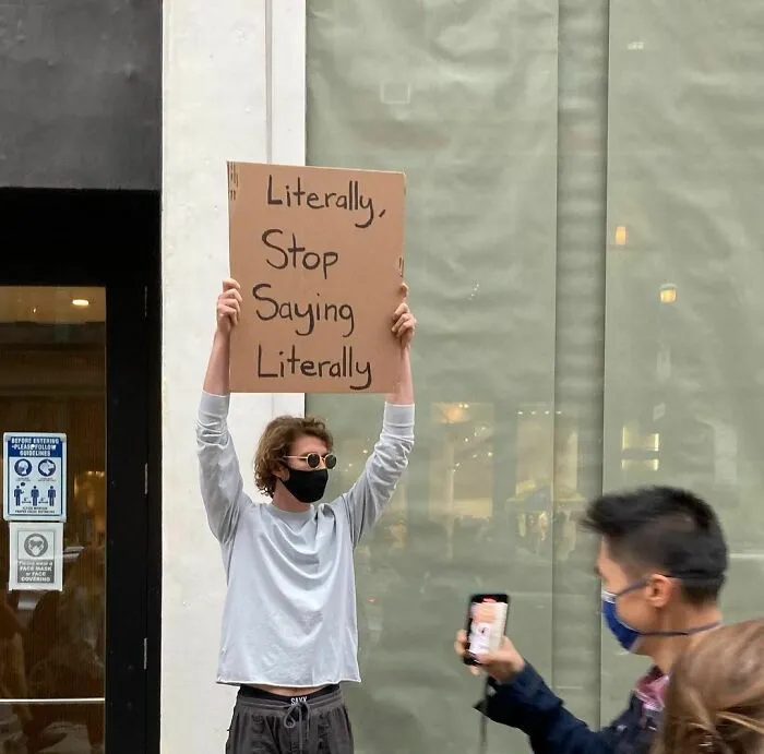 30 Hilarious Pictures Of A Man Protesting Obscure Things