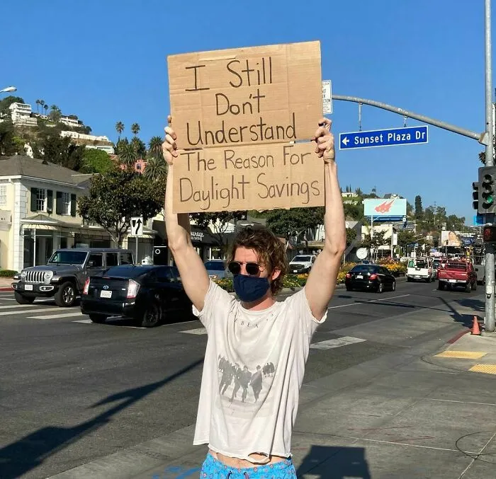 30 Hilarious Pictures Of A Man Protesting Obscure Things